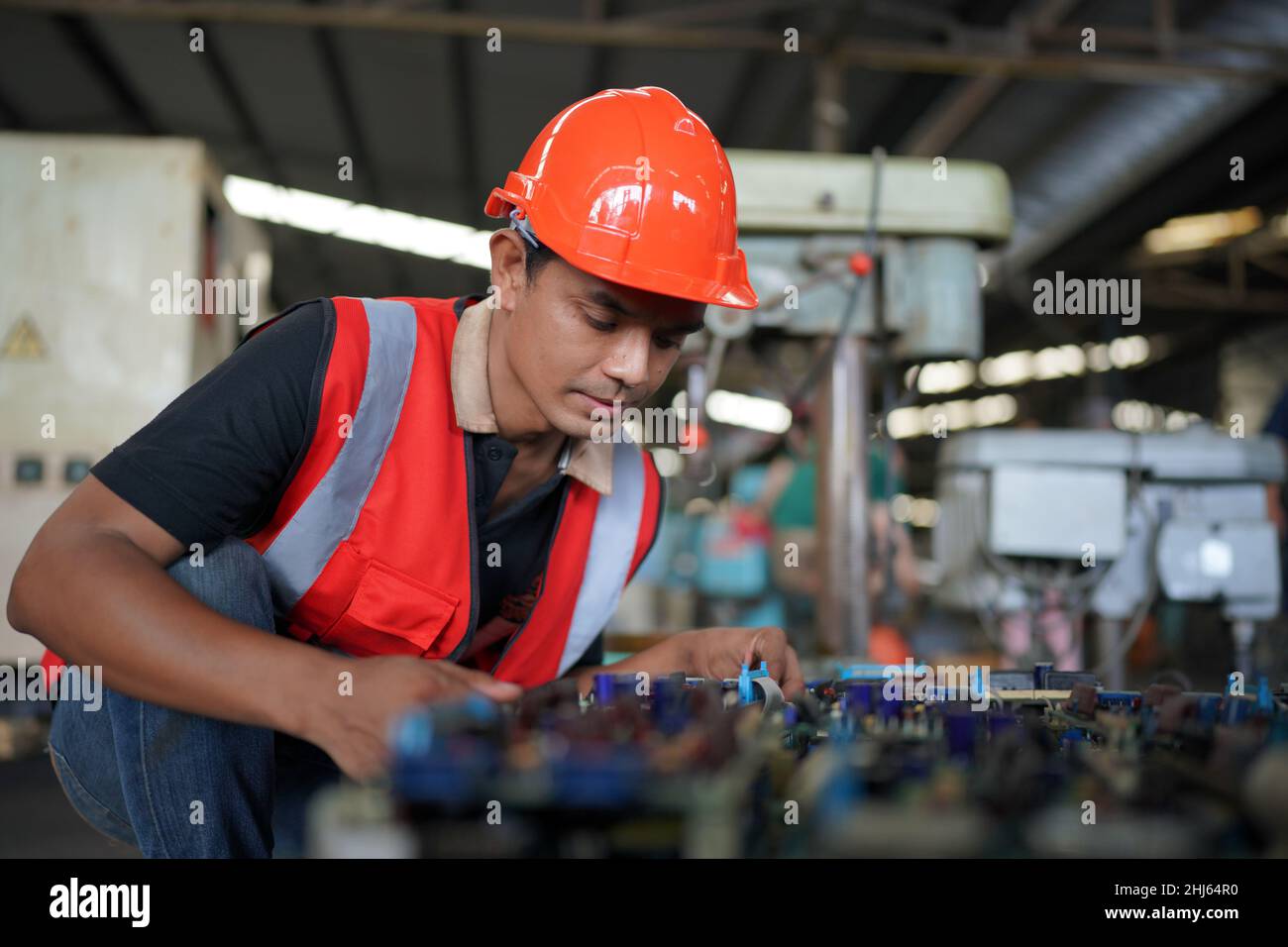 Professional engineer metalworker operating CNC milling machine center ...