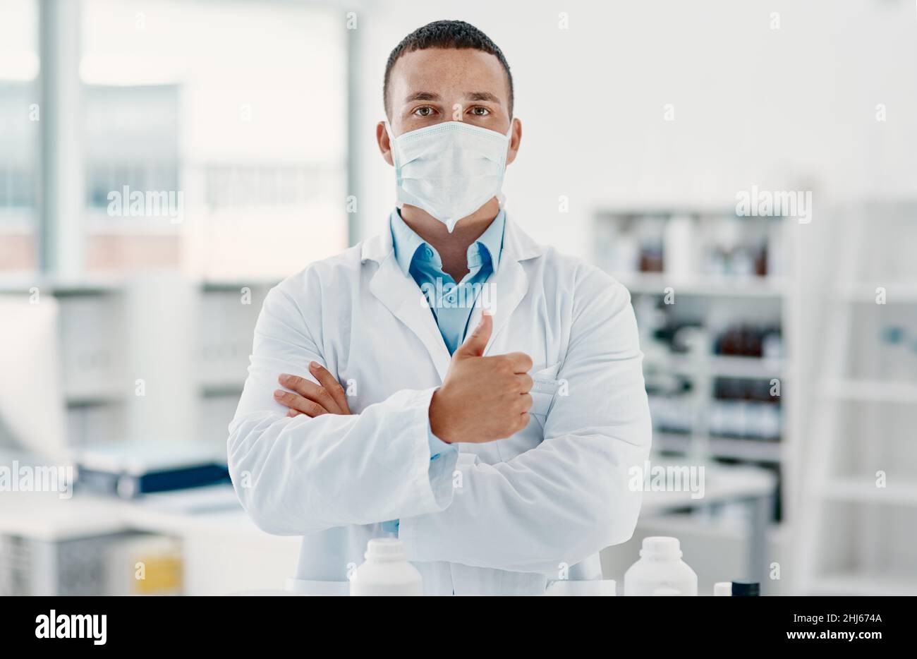 The cure is coming. Portrait of a confident young scientist showing ...