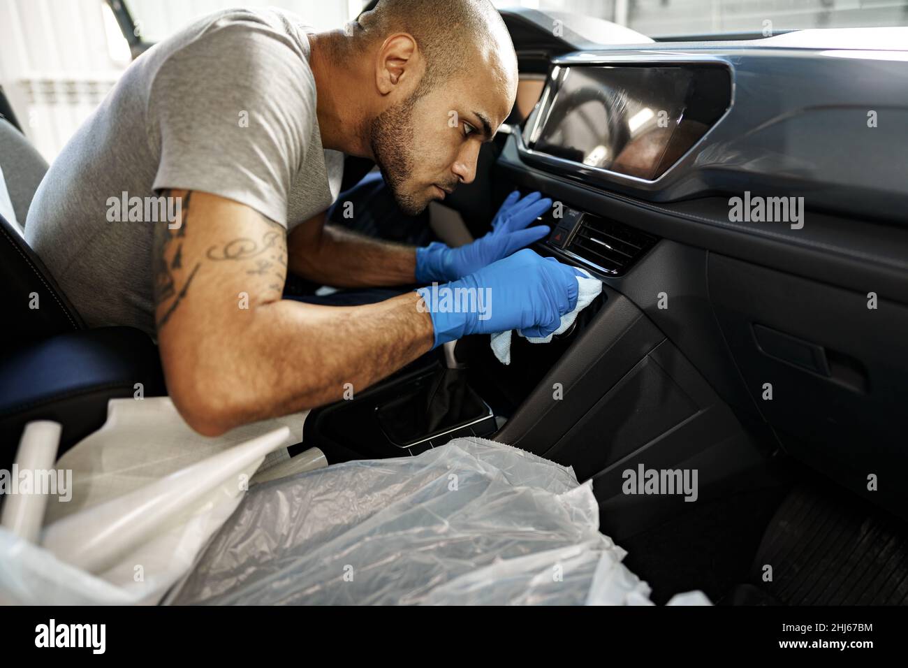 A man cleaning car interior, car detailing in Carwash service Stock ...