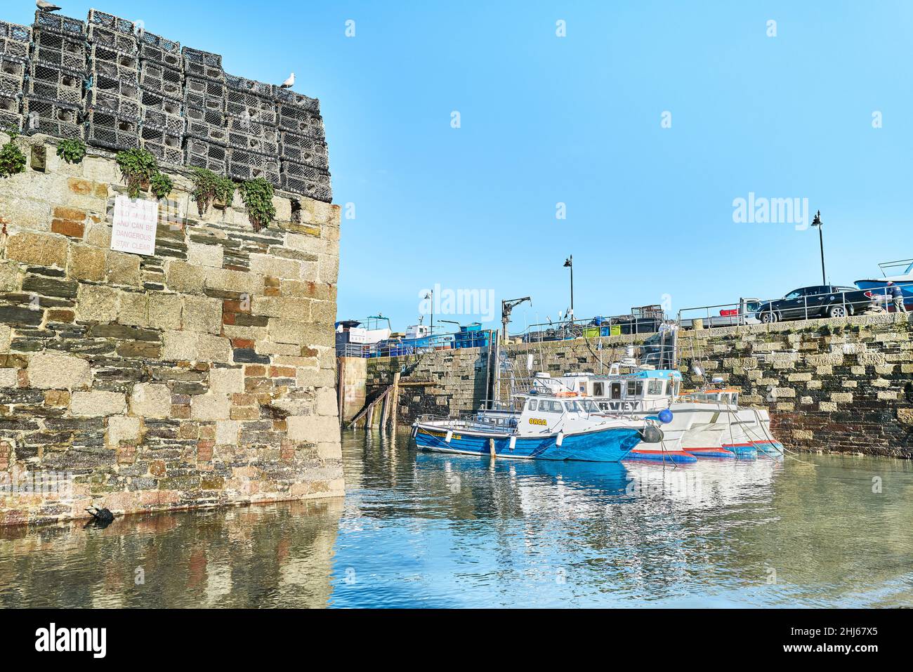 A stack of lobster pots in the harbour at Newquay, Cornwall, England ...