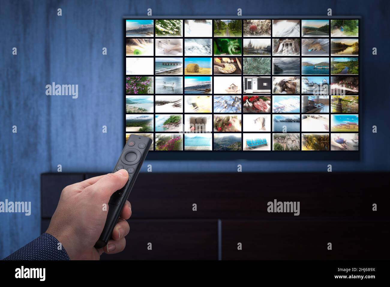 Video on demand service on smart TV. Person sitting at home late at ...