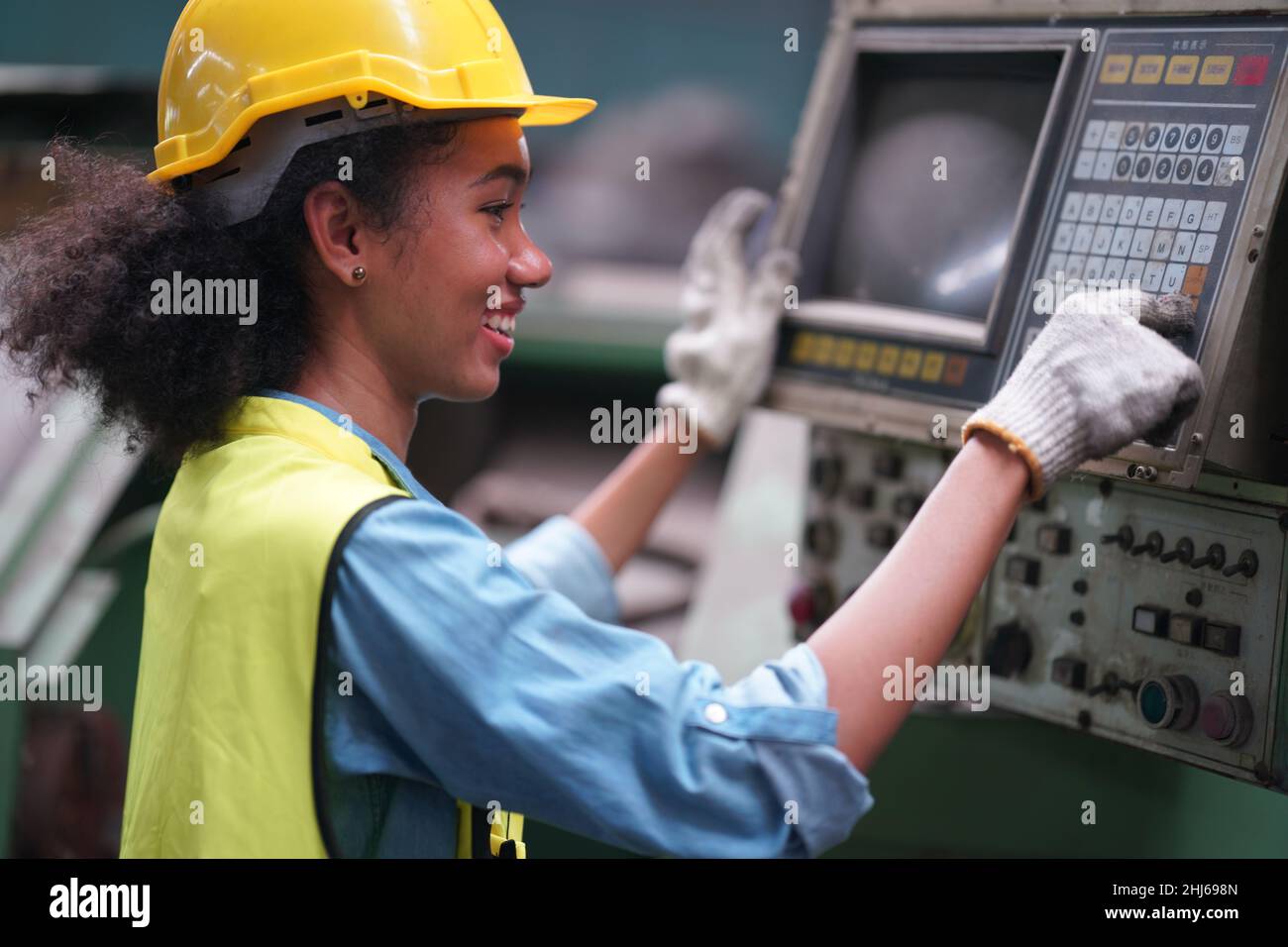 Female apprentice in metal working factory, Portrait of working female ...