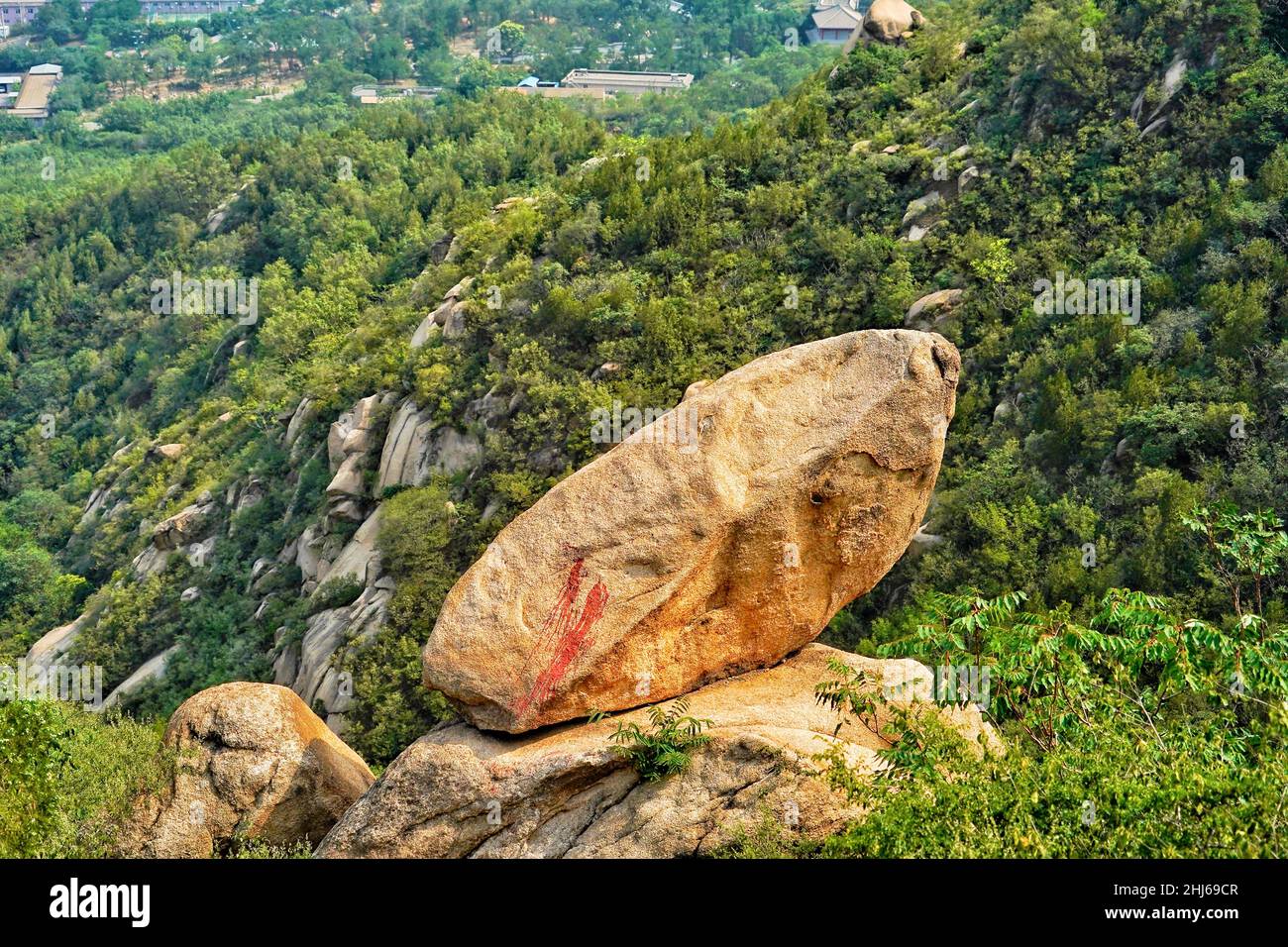 Stone lying on the tall green mountain in China Stock Photo - Alamy