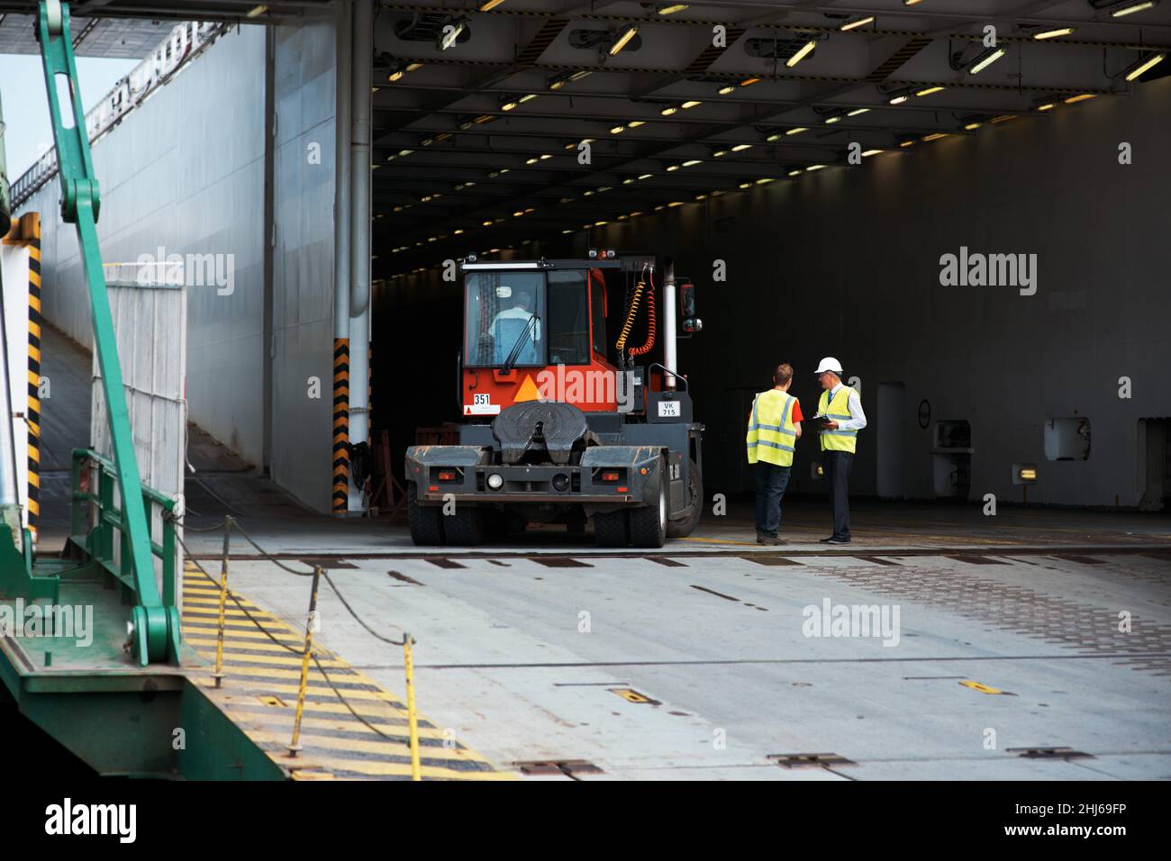 Teamwork is the driving force. Co-workers standing next to a truck on a ...