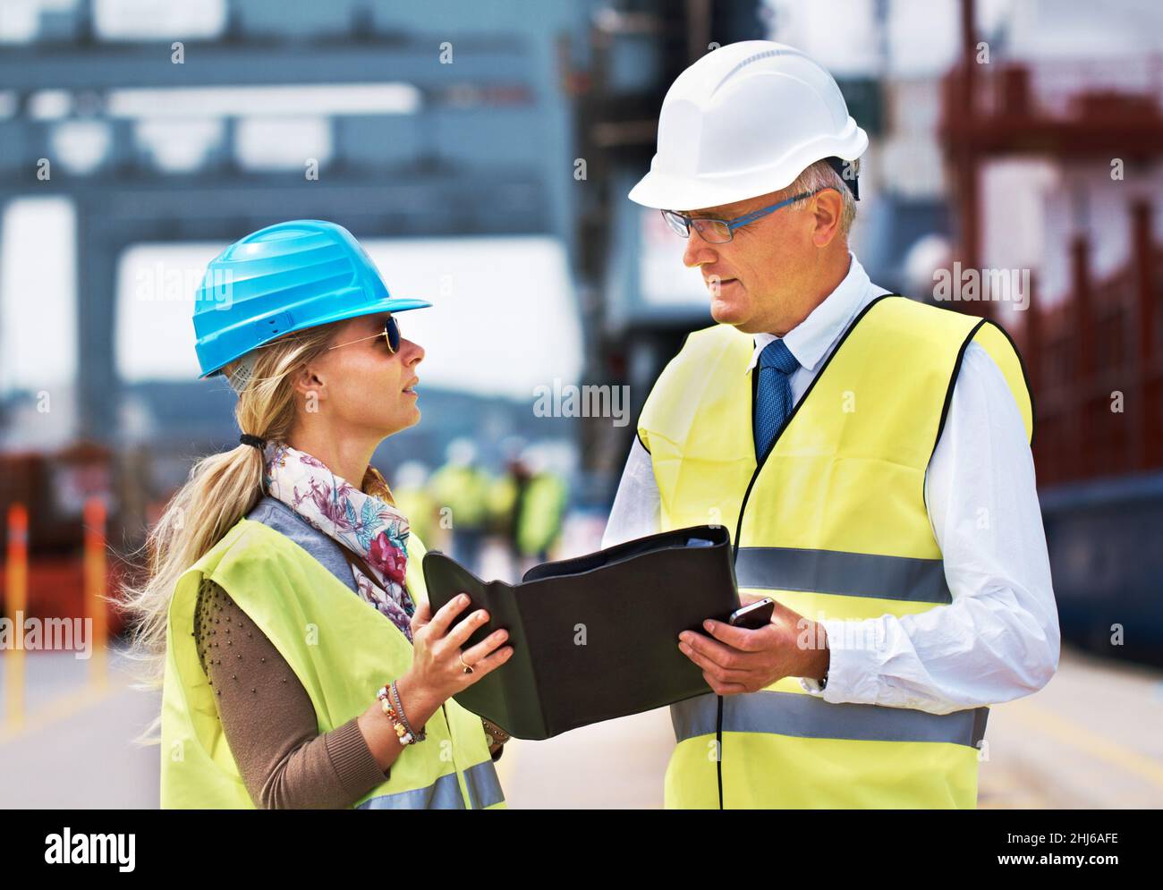 Working together creates success. Two work colleagues standing in a ...