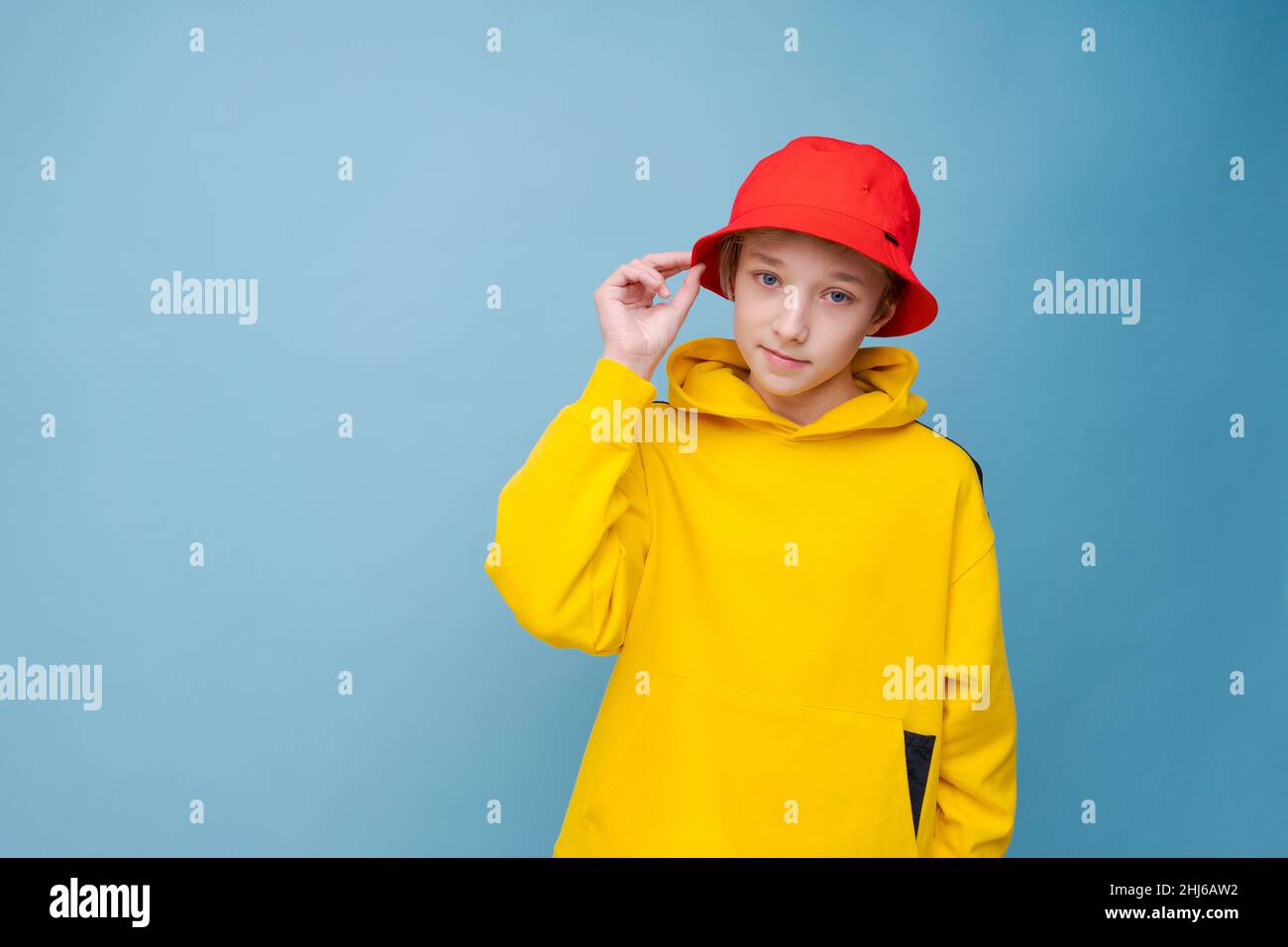 Portrait of positive guy in yellow jacket and a red panama hat on a ...