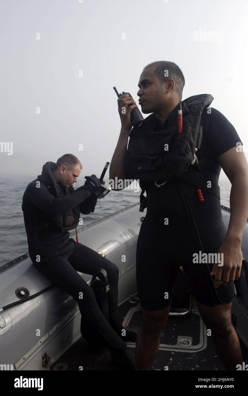 Surface search and rescue (SAR) swimmers Lt. Patrick Panjeti, right ...