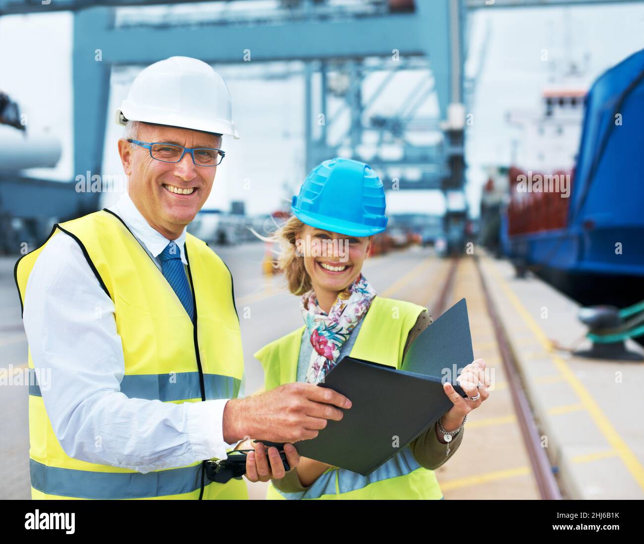 We work well together. Two dock workers conferring among themselves ...
