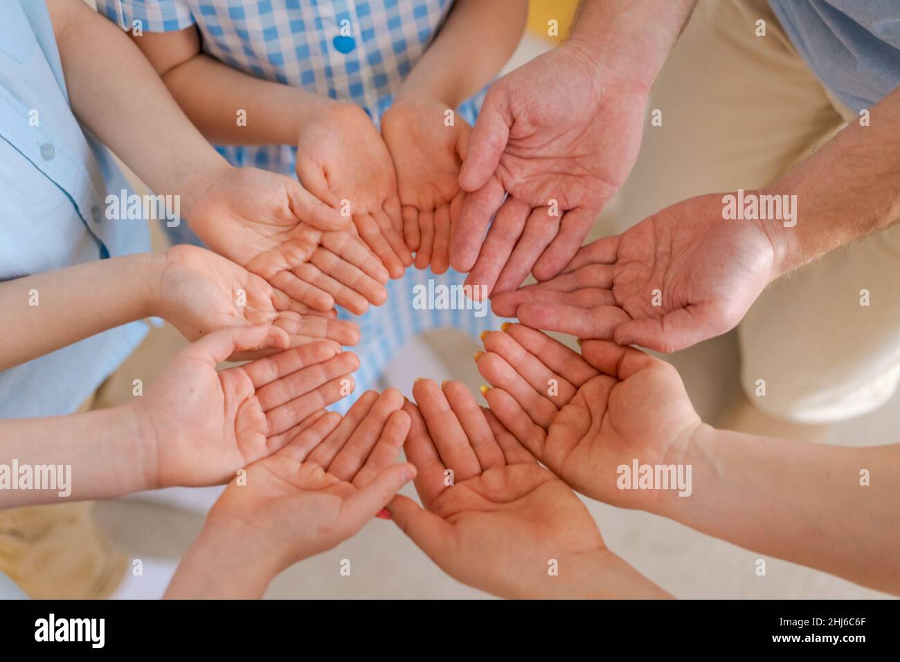Large family holds palms their hands together, concept happiness in the ...