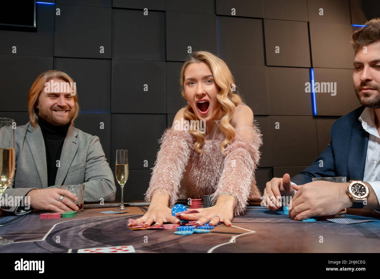 Happy excited woman winning poker game raking game chips Stock Photo ...