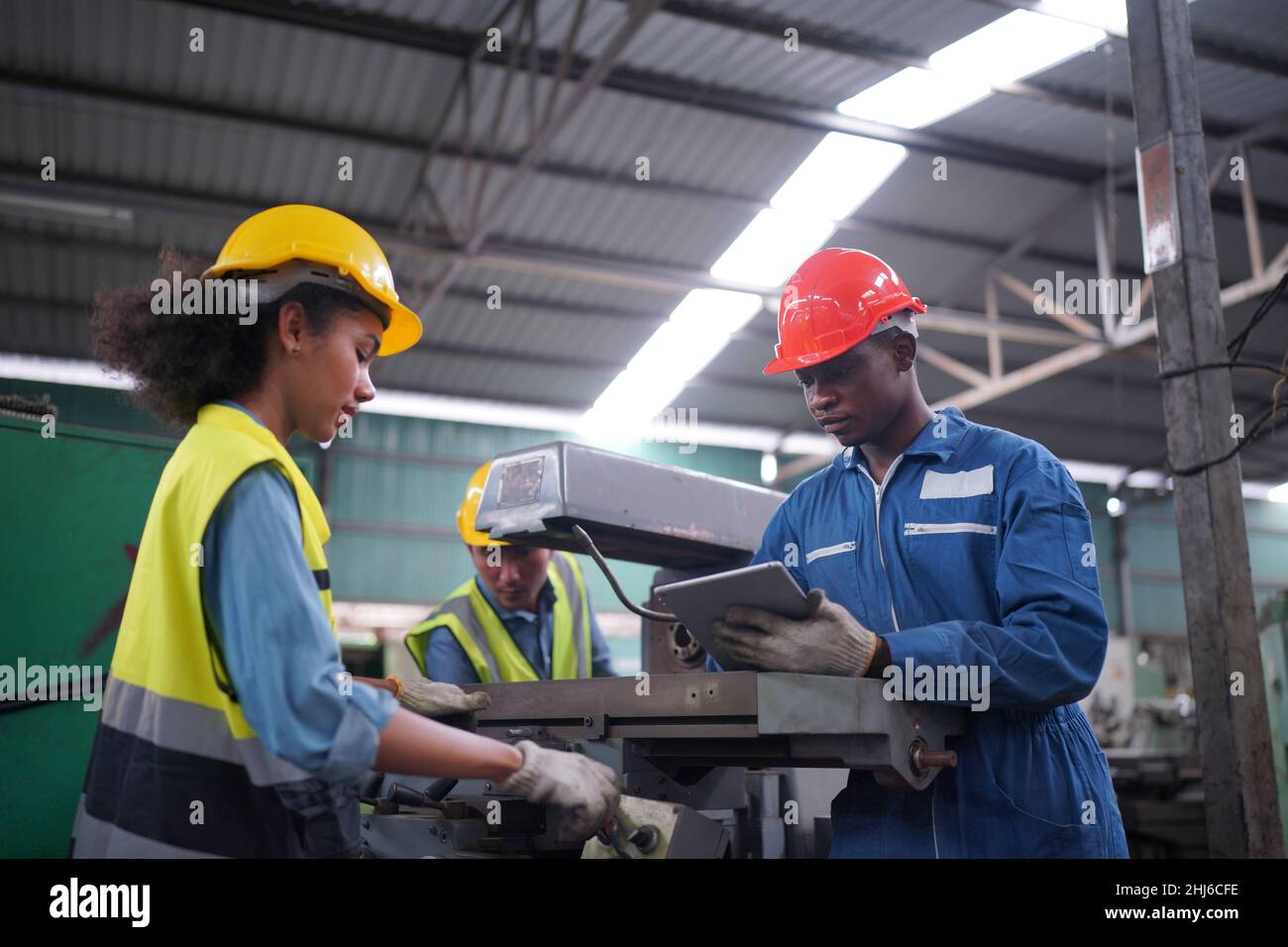 Female apprentice in metal working factory, Portrait of working female ...