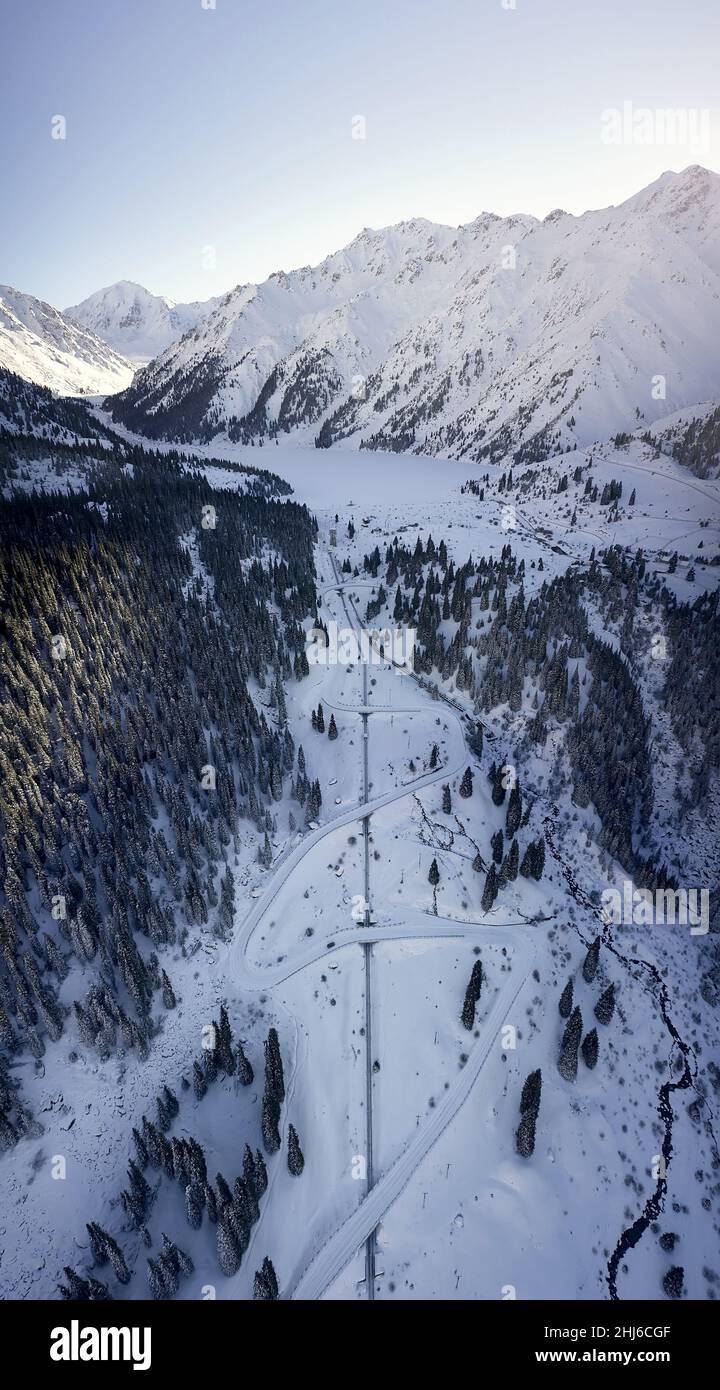 Top view of a snowy mountain landscape with trees and road to Big ...