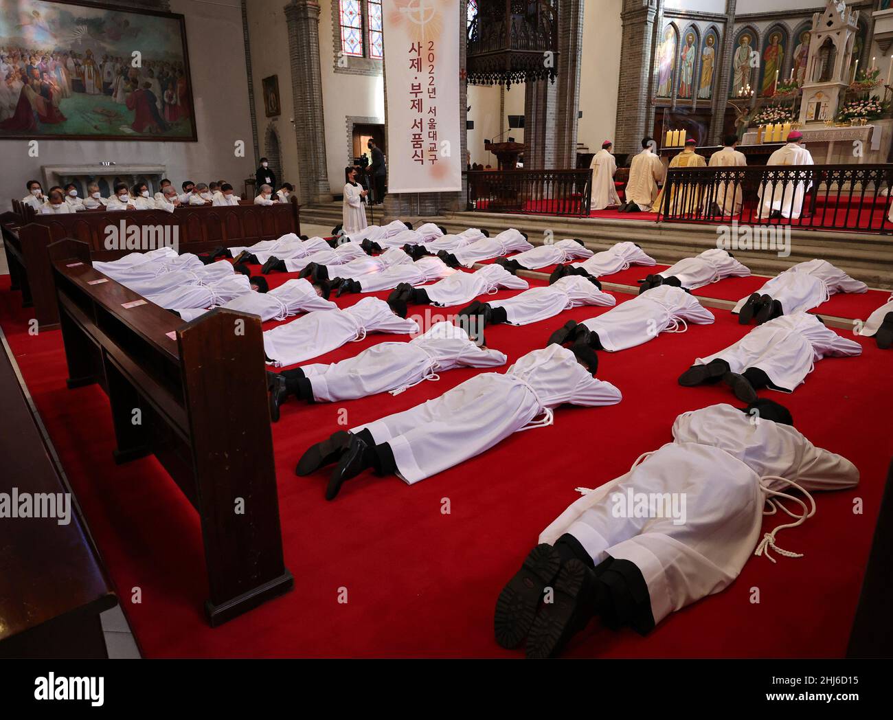 27th Jan, 2022. Catholic ordination New priests prostrate during an ...