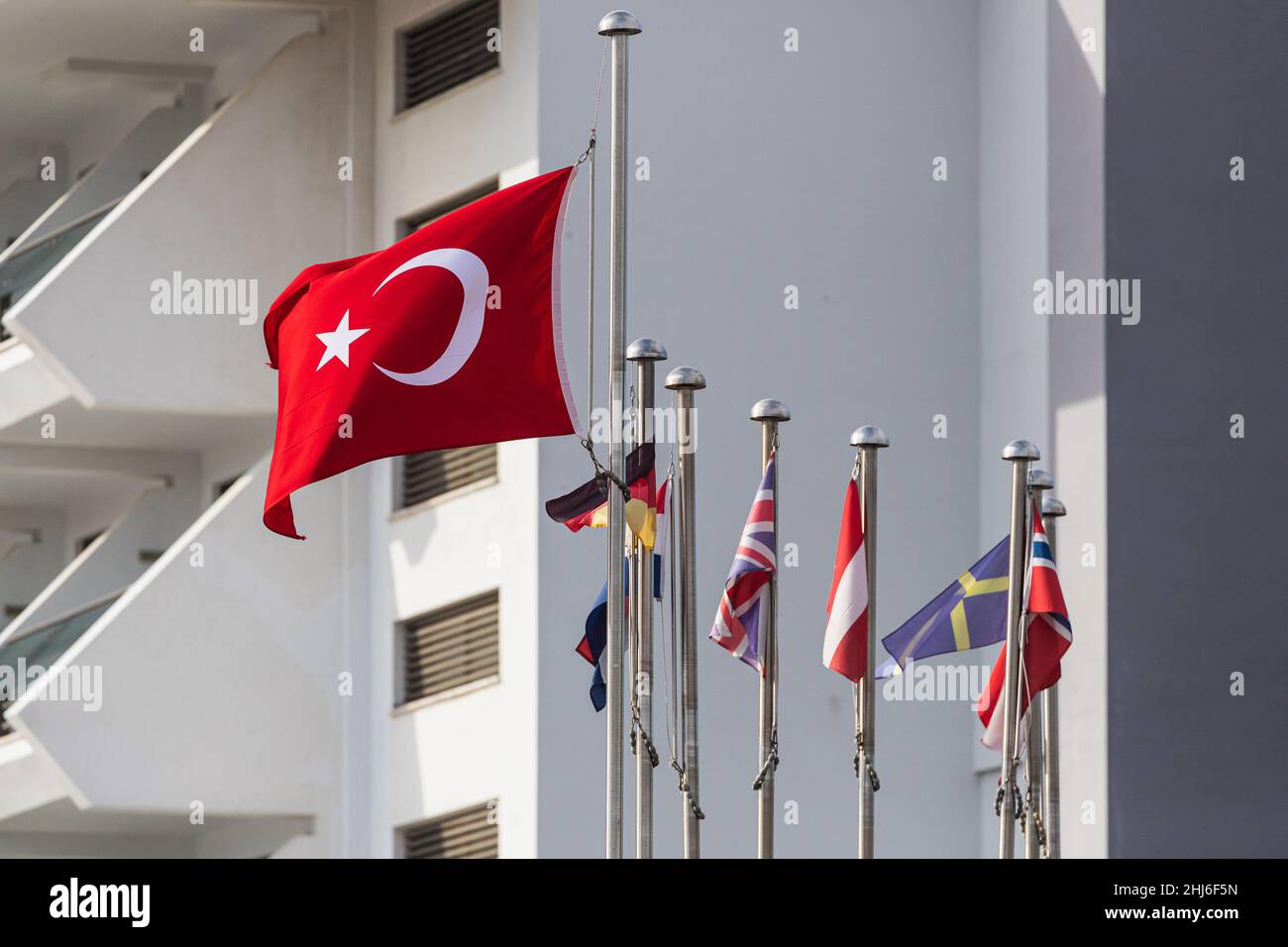 National flag of Turkey on a flagpole waving in backdrop many others ...