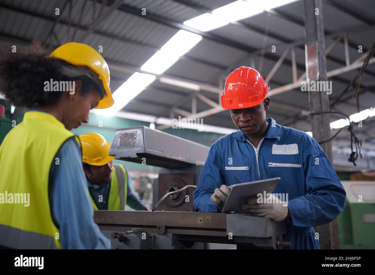Female apprentice in metal working factory, Portrait of working female ...