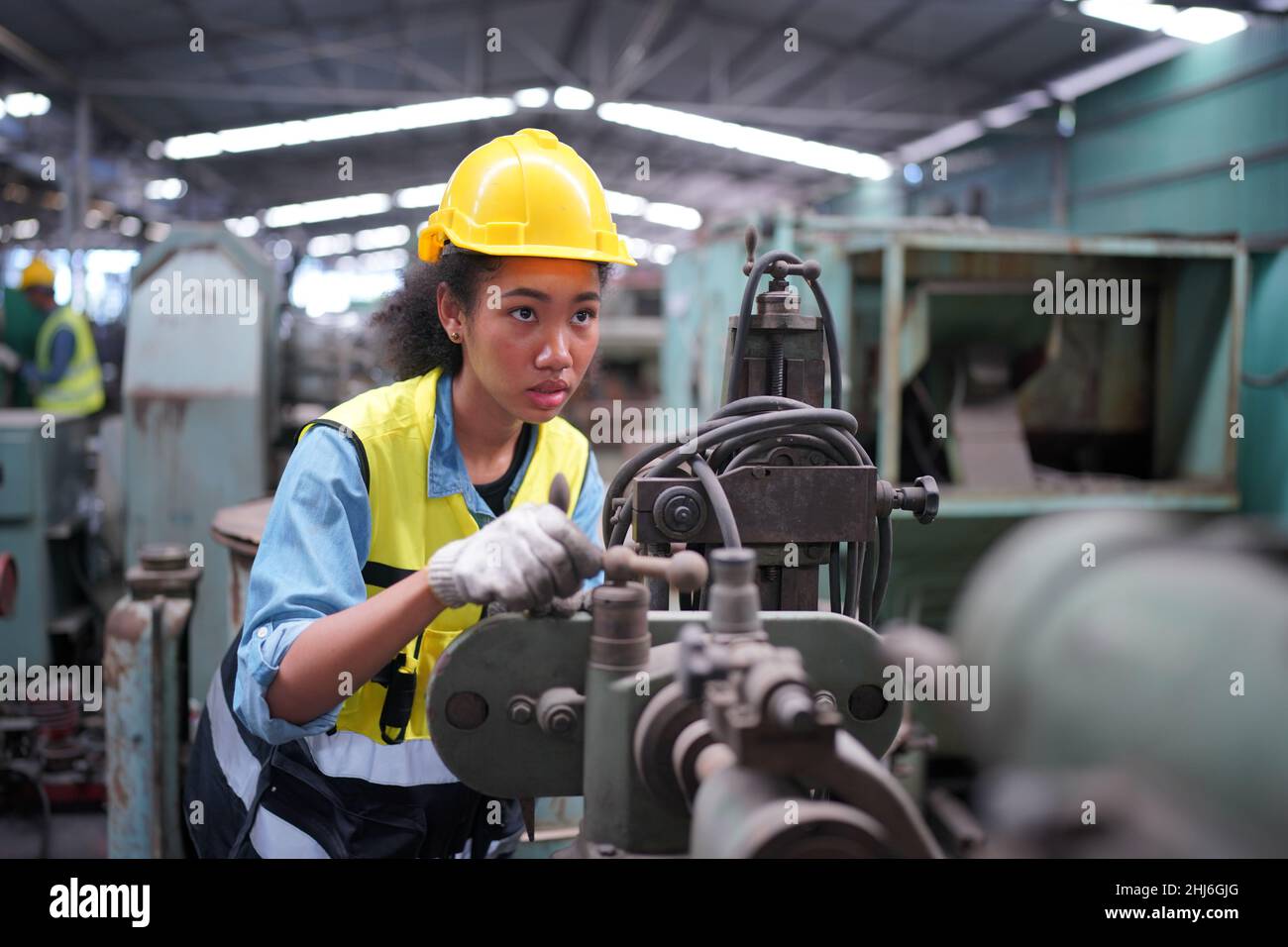 Female apprentice in metal working factory, Portrait of working female industry technical worker ...
