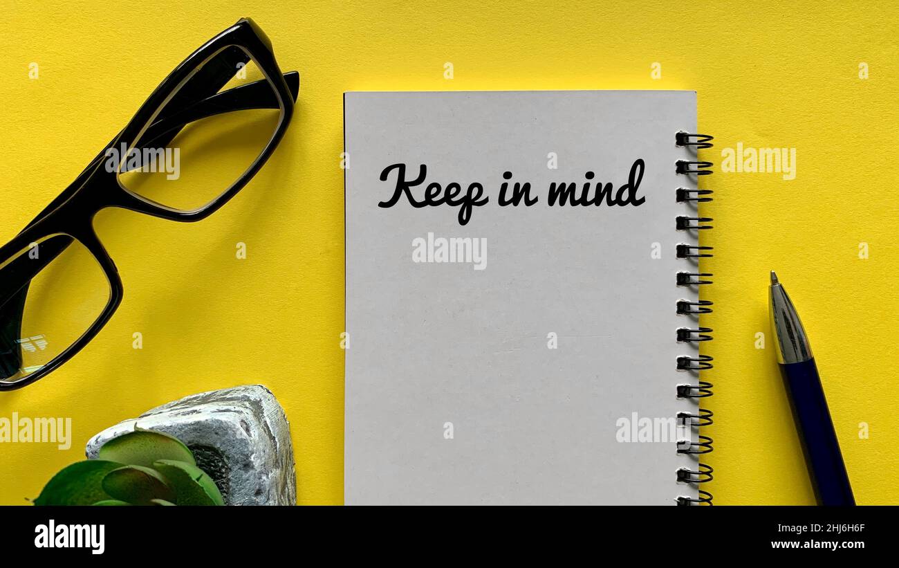 Keep in mind text on notebook with glasses and plant background ...