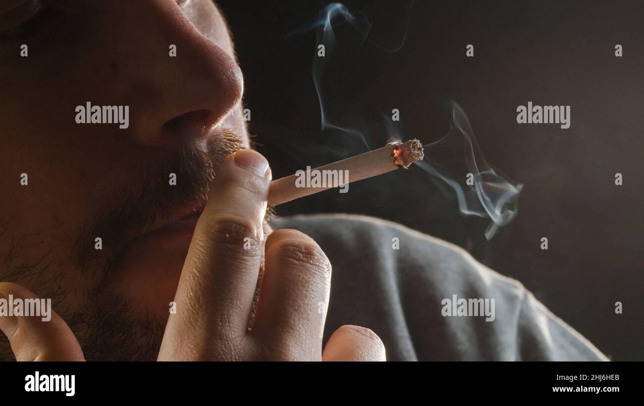 Man smoking a cigarette, close up. unhealthy addiction Stock Photo - Alamy