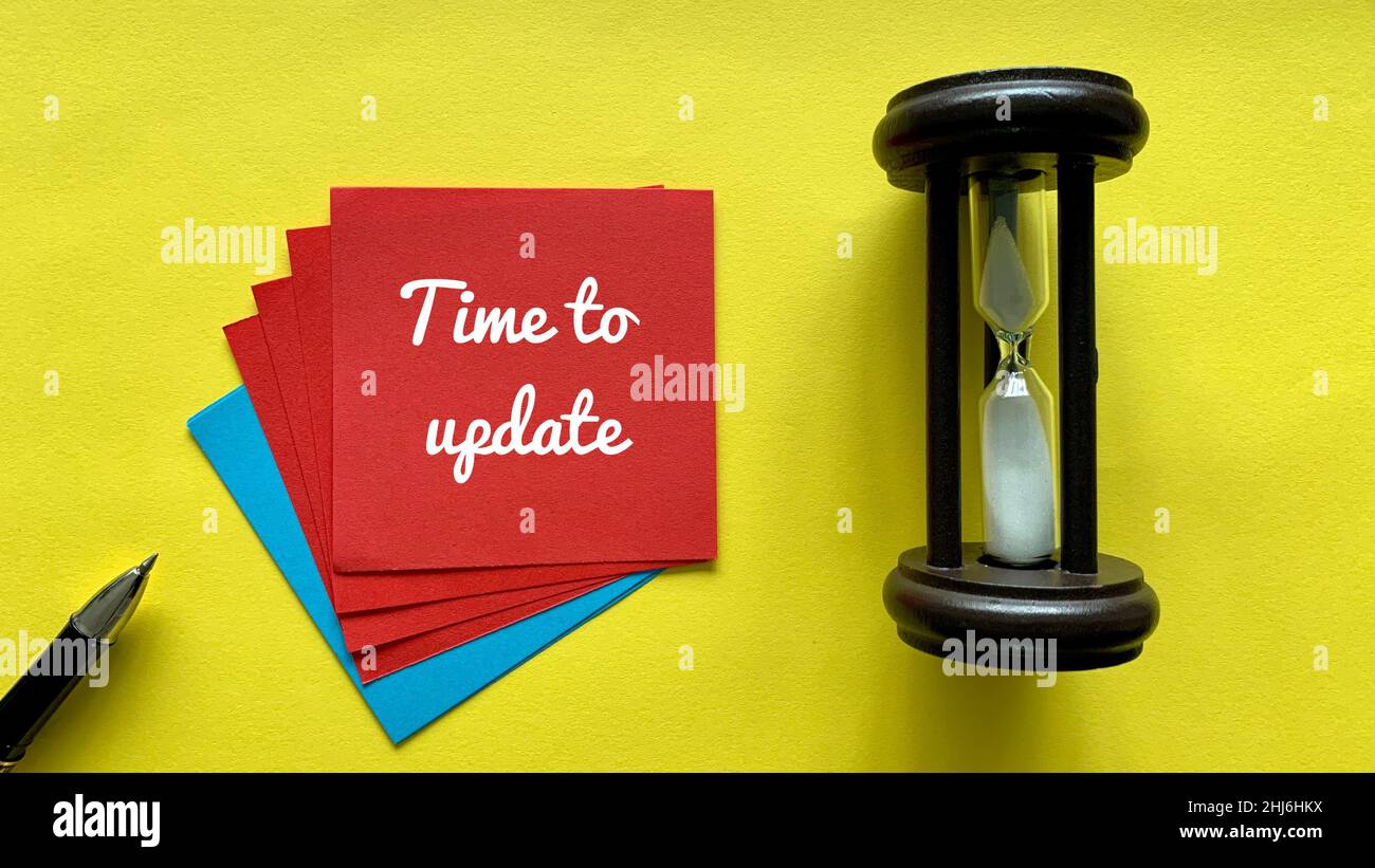 Top view of red sticky note with time to update text. With minutes ...