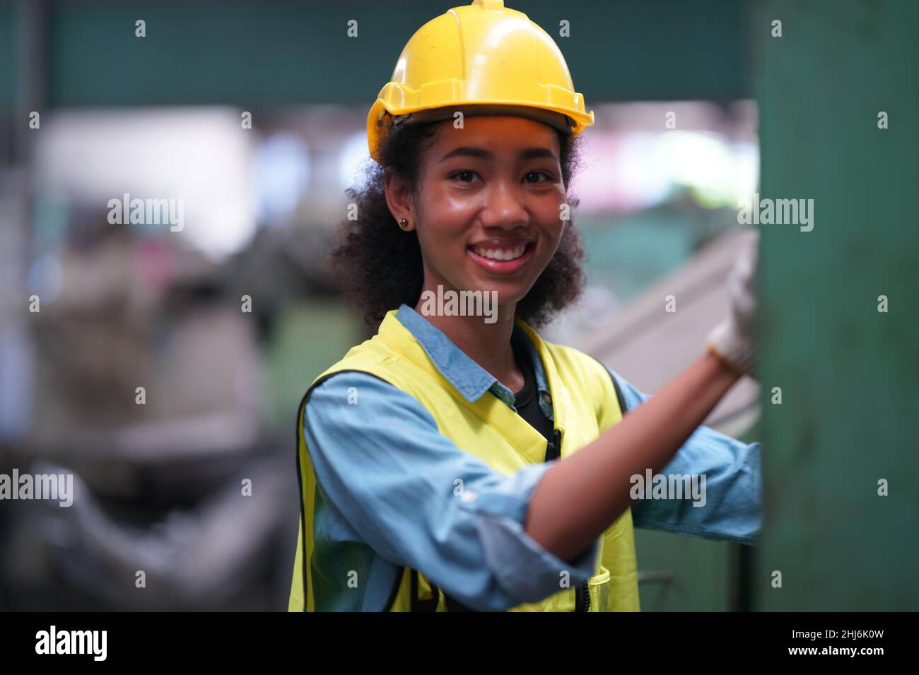 Female apprentice in metal working factory, Portrait of working female ...