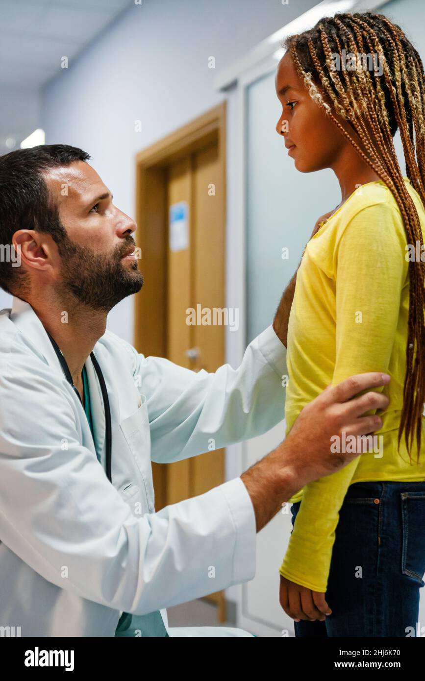 Male doctor comforting depressed sad kid patient Stock Photo - Alamy