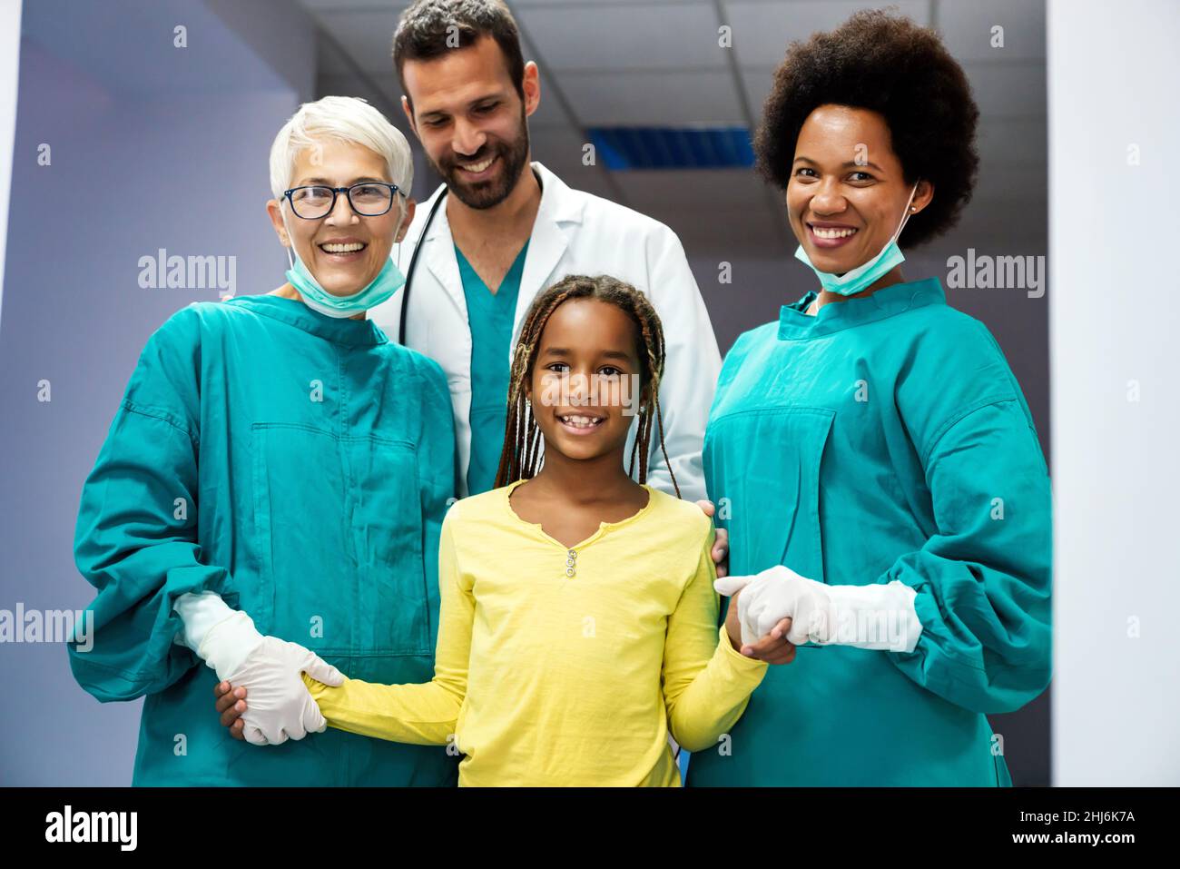 Team of experienced highly qualified doctors with child patient after a ...