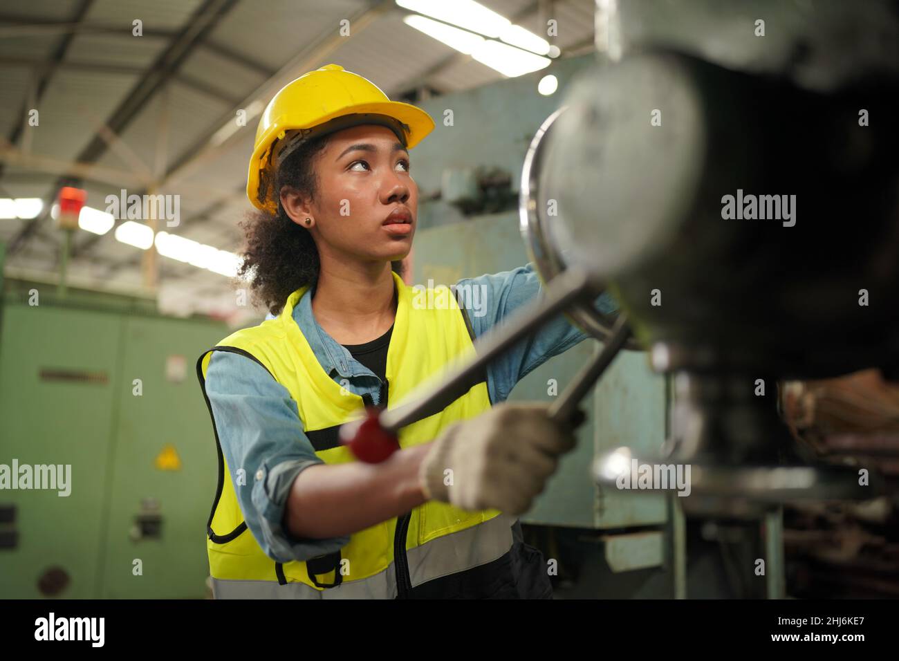 Female apprentice in metal working factory, Portrait of working female ...