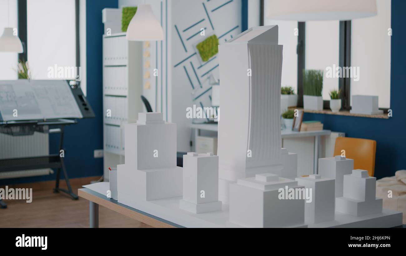 Table with building model and maquette presentation in empty ...