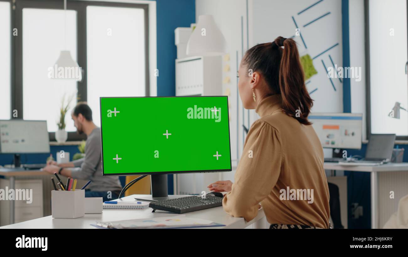 Company worker using computer with green screen in office. Business ...