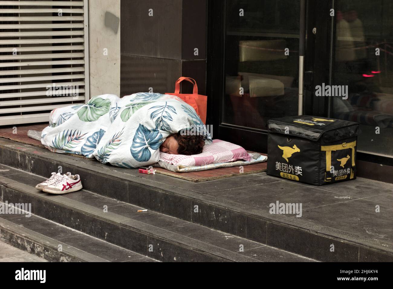 Chinese homeless person sleeping on ground in Shenzhen, China Stock ...