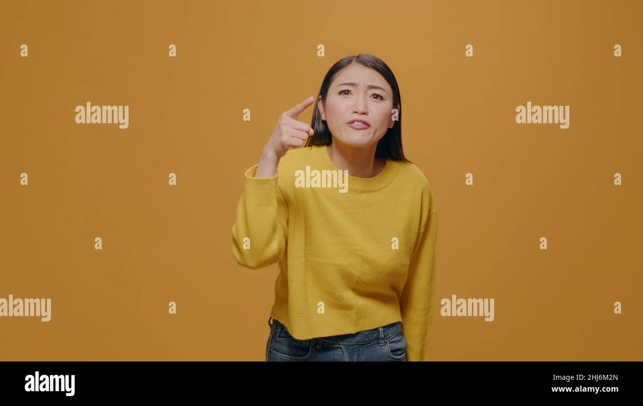 Angry woman showing index finger at camera and having argument, feeling ...