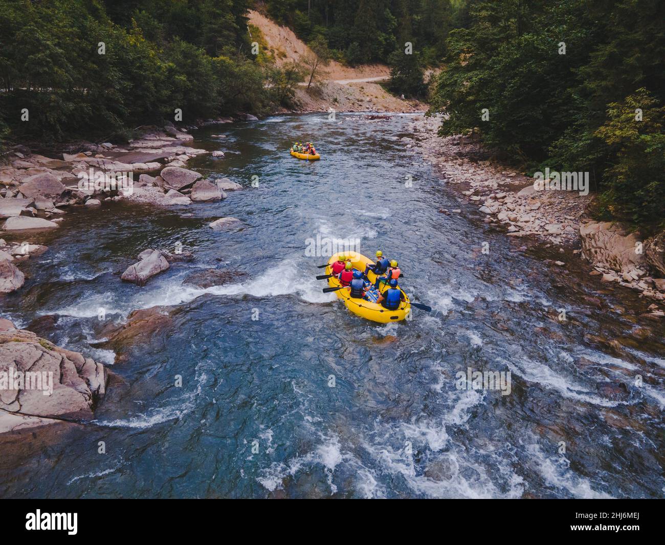 aerial view of mountain river people rafting in creek. extreme vitality ...