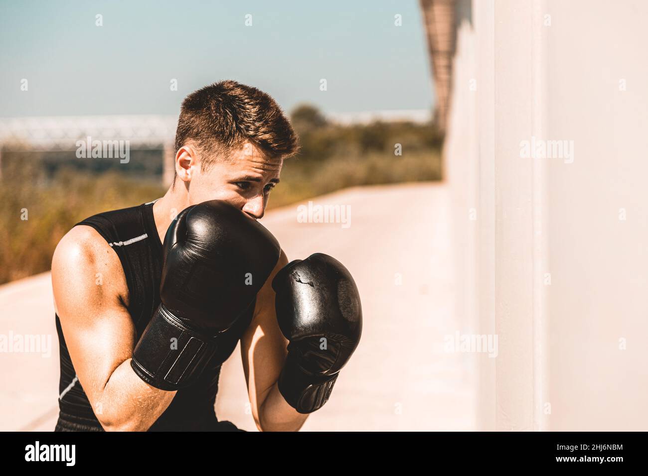 Man exercising and fighting in outside, boxer in gloves. male boxer ...