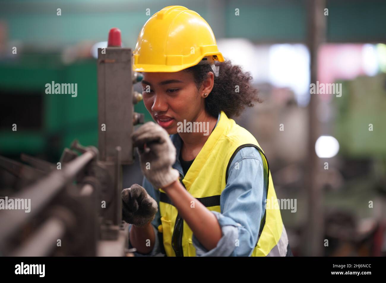 Female apprentice in metal working factory, Portrait of working female ...