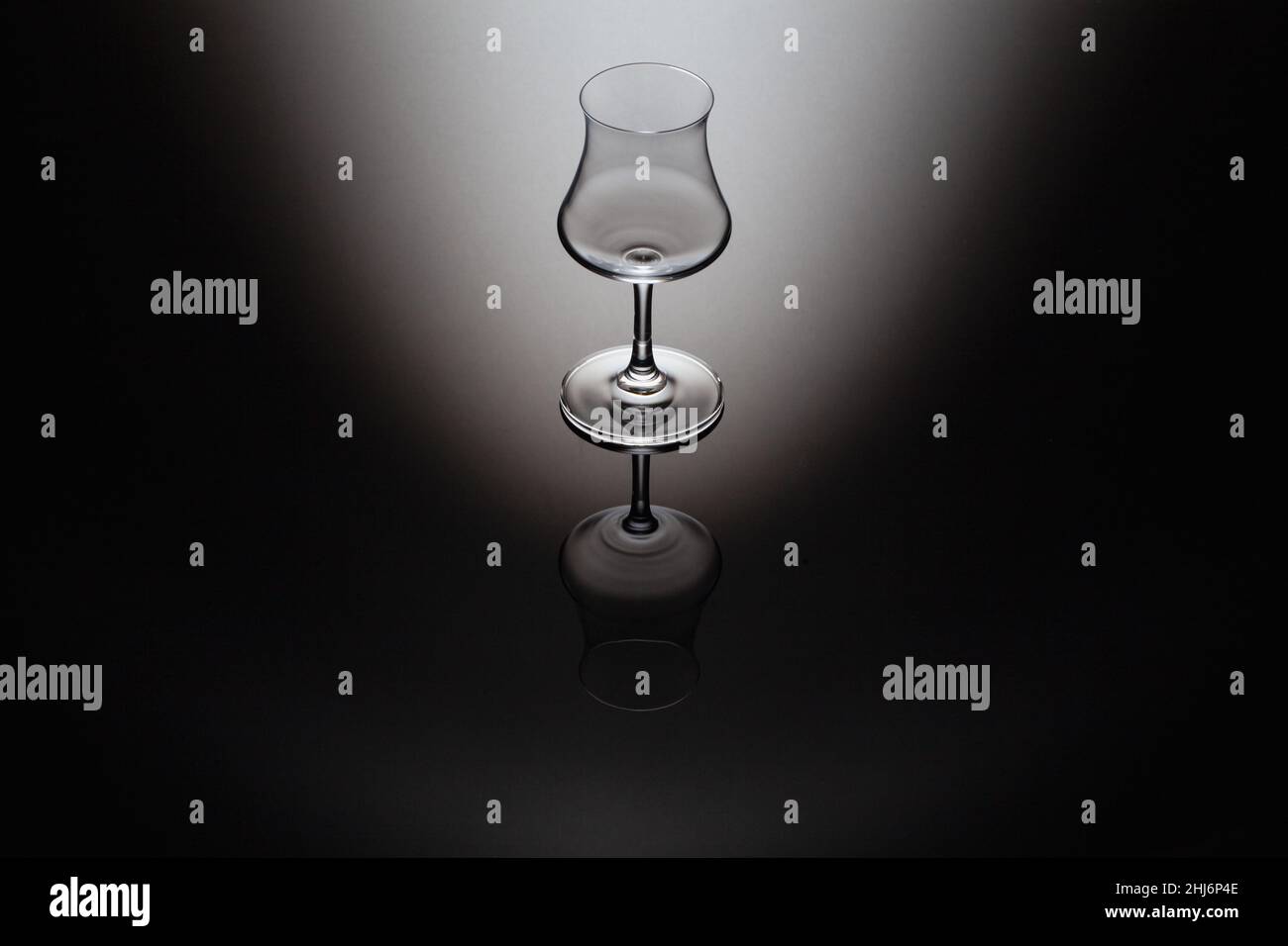 Rum tasting glass on the glass table and black background Stock Photo ...