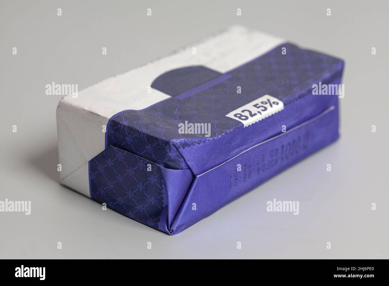 Stick of wrapped butter on grey background Stock Photo - Alamy