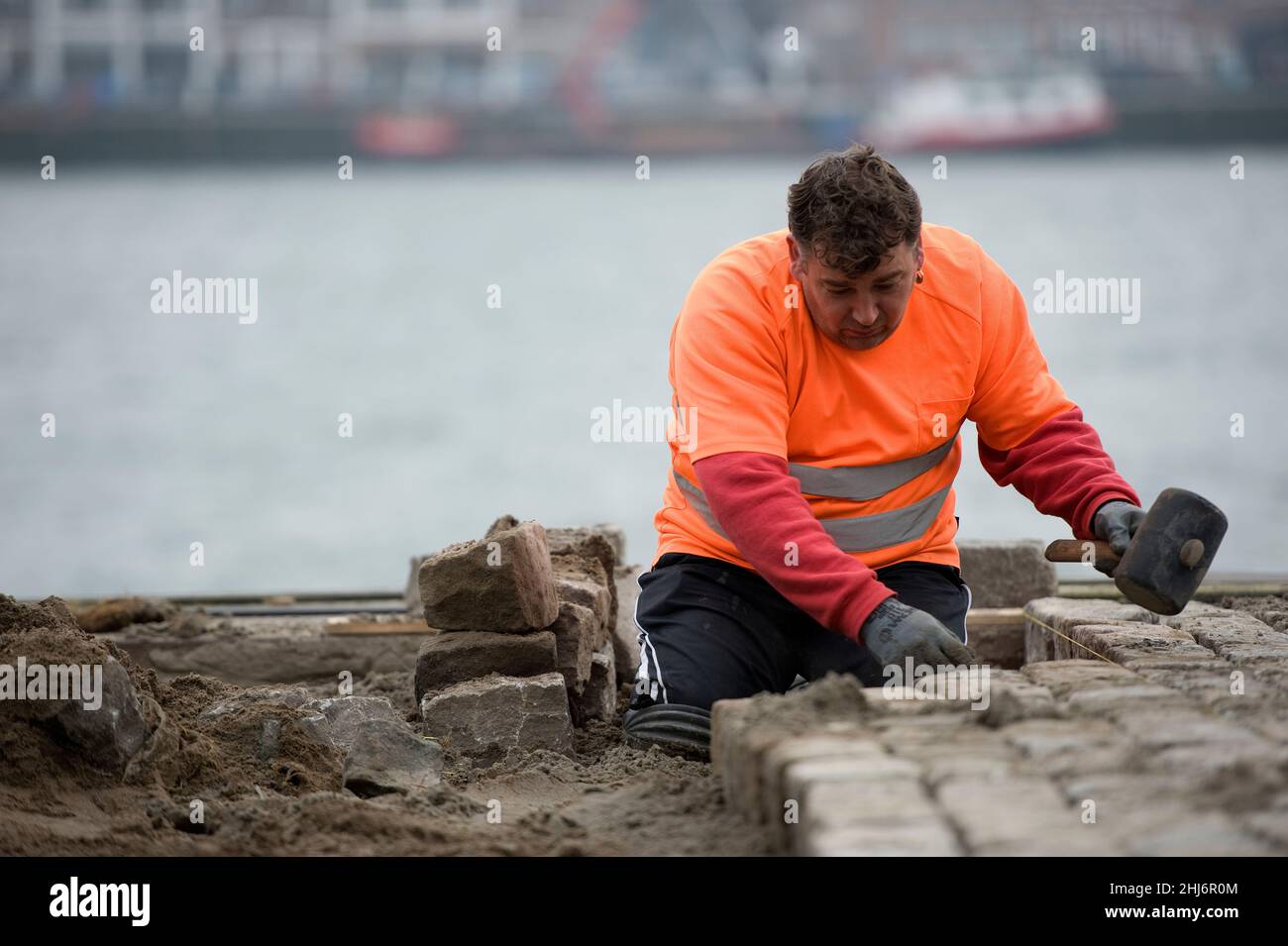 Rotterdam, Netherlands. A Dutch, Male Road Worker making and paving a ...