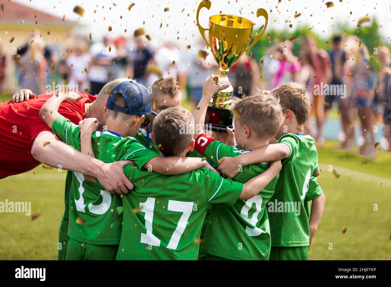 Happy kids winning sports tournament. Schoolboys standing with a coach ...