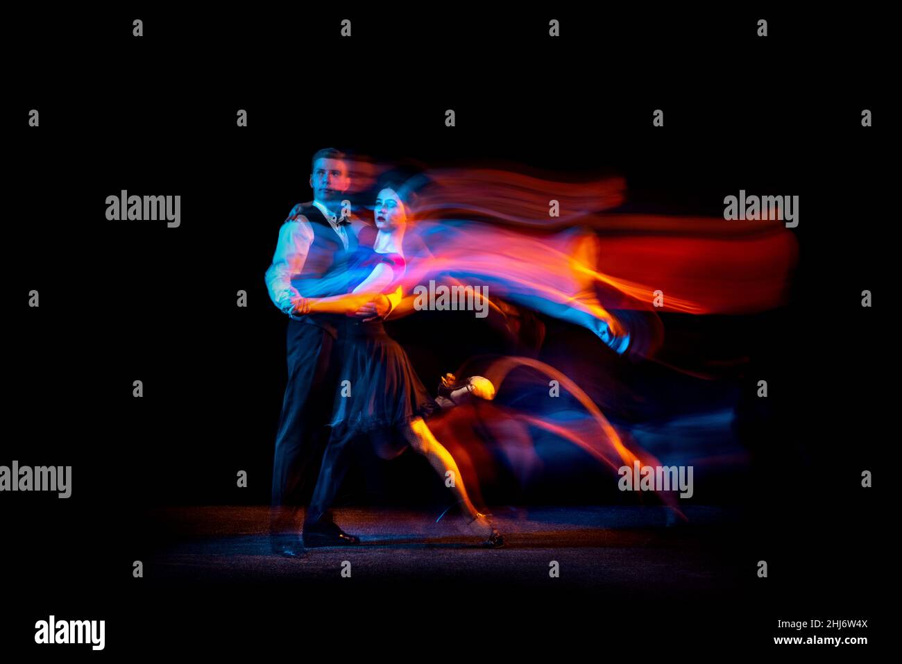 Dynamic portrait of young ballroom dancers dancing Argentine tango ...