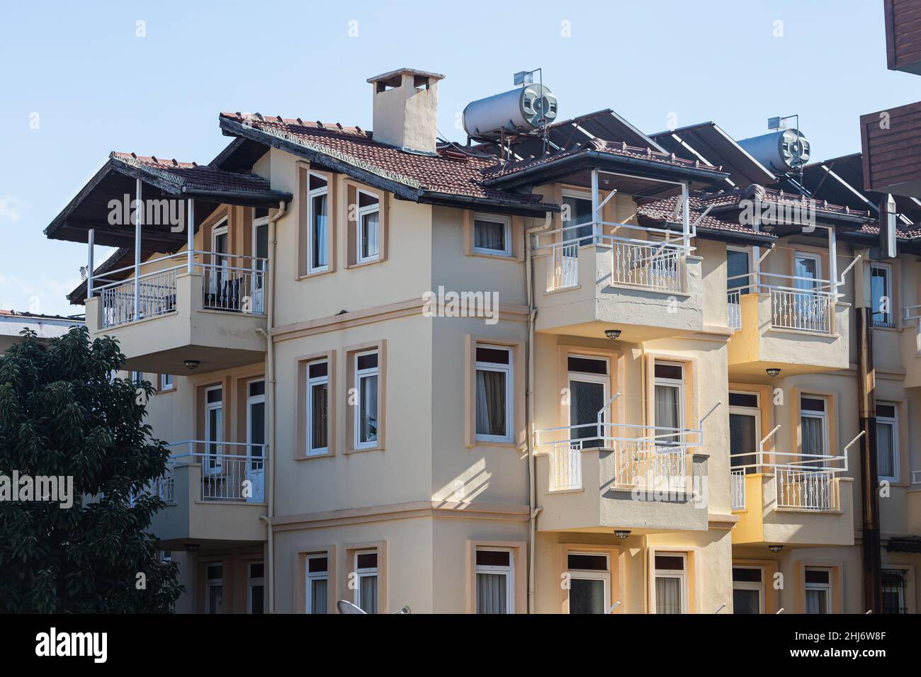 view of the old ancient house with black roof and trees in Turkey. Side ...