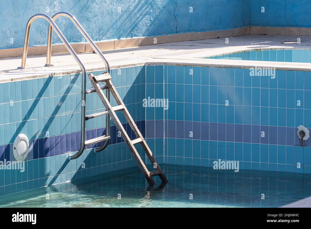 Handrails for dirty water pool. Swimming pool with ladder in a tropical ...