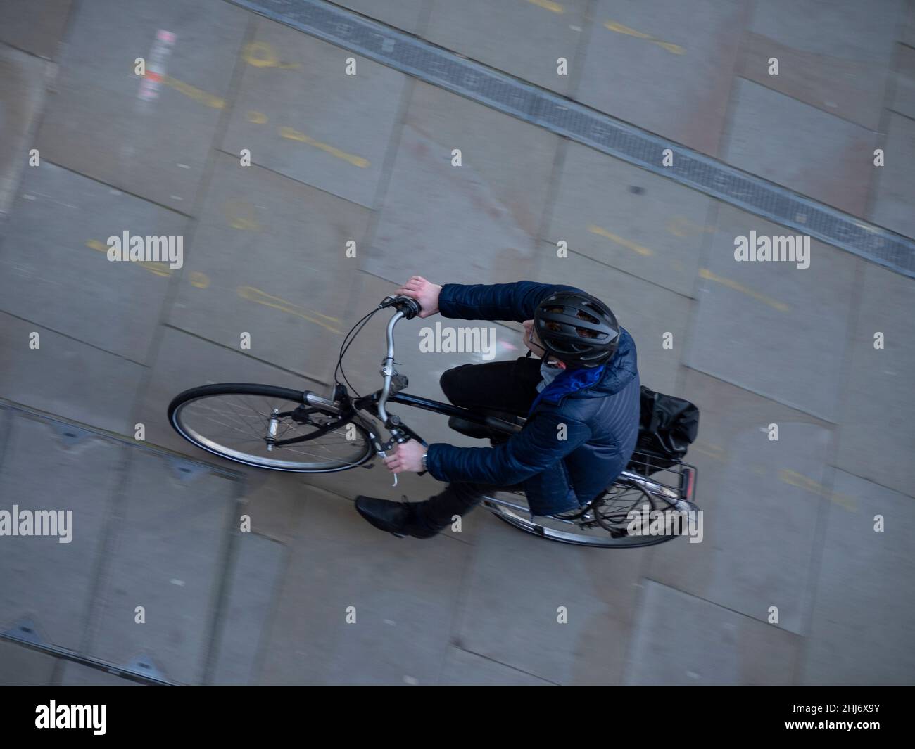 Cyclist riding bike on pavement, Barbican, London Stock Photo - Alamy