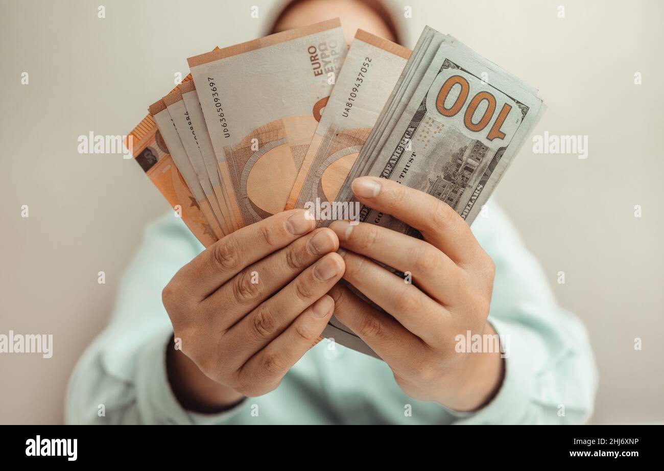 Money winner. Happy rich business woman covering her face with money on ...