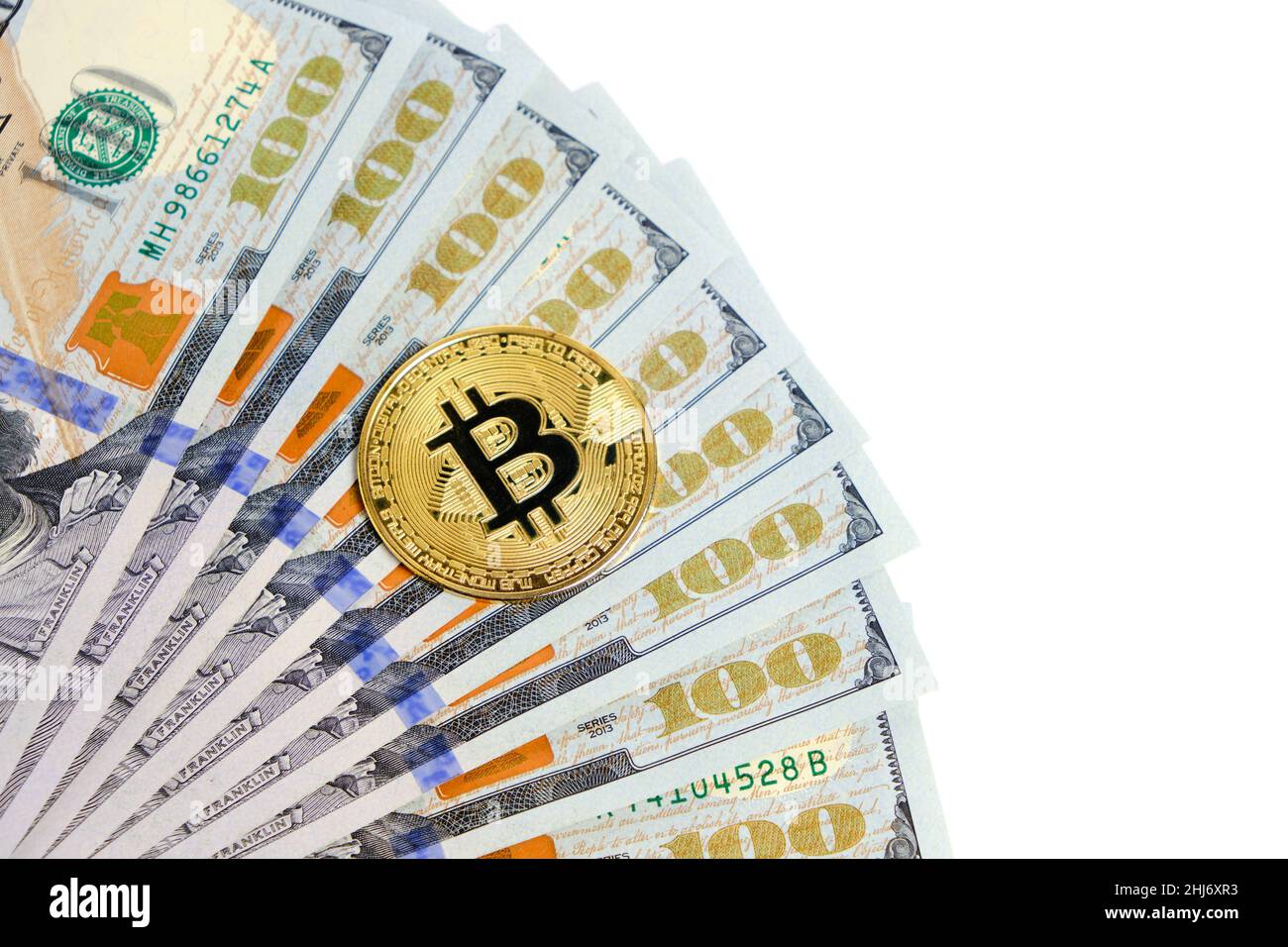 An unfolded bundle hundred dollar bills and one bitcoin coin on white ...