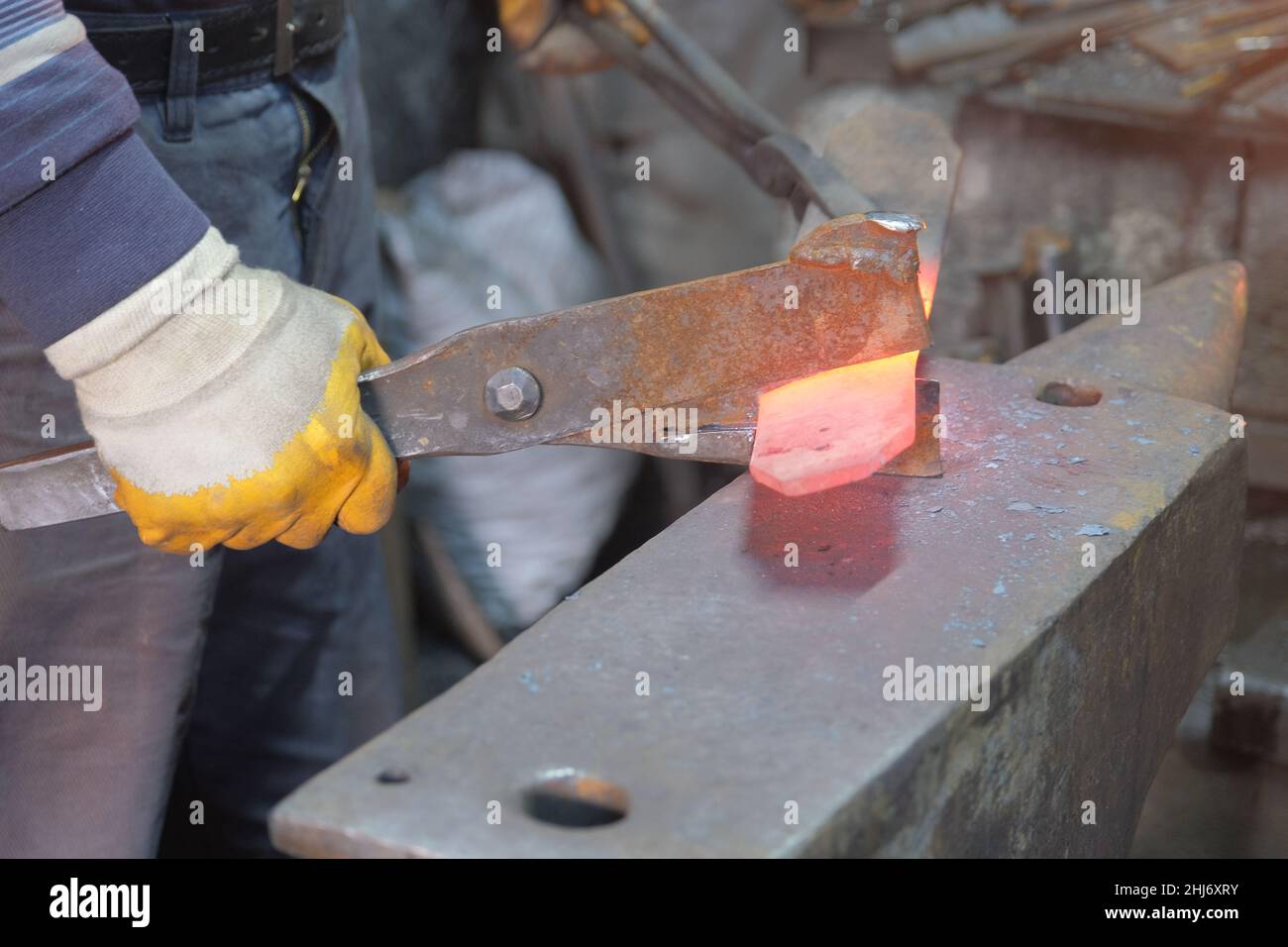 Heated iron, anvil and forging by a man. forging of wrought iron Stock ...
