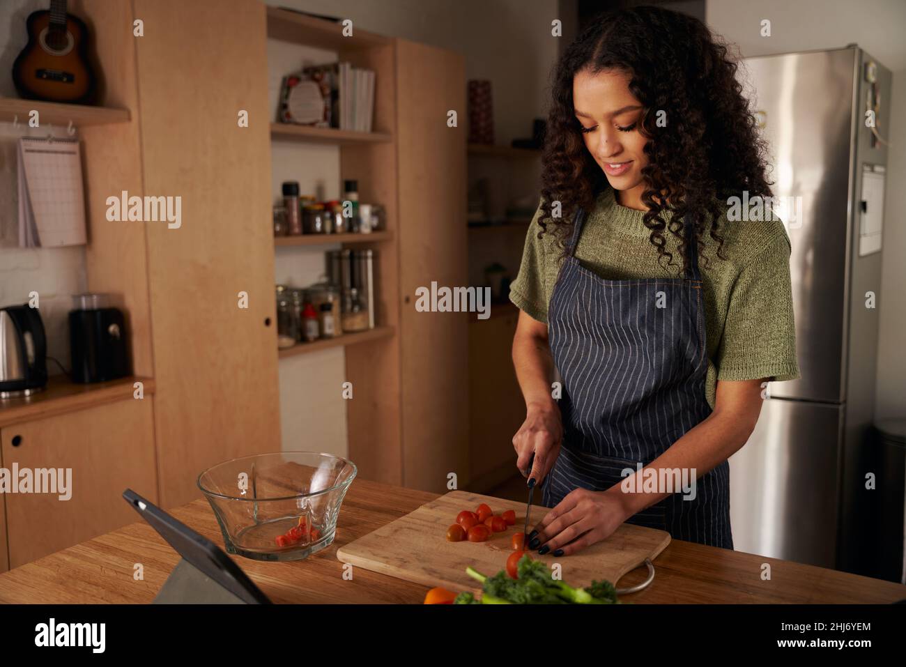 African American woman cooking at home chopping vegetables Stock Photo ...