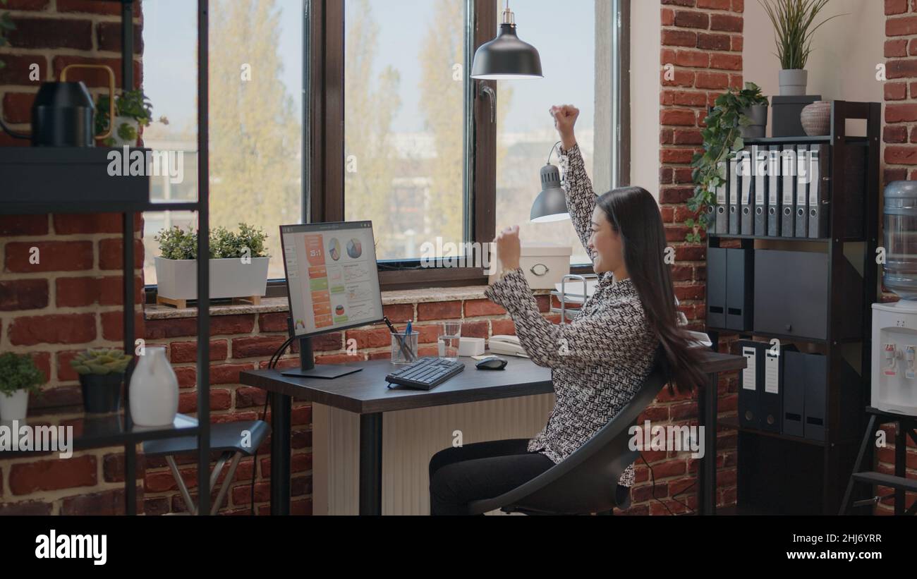 Satisfied woman celebrating business achievement on computer. Person ...