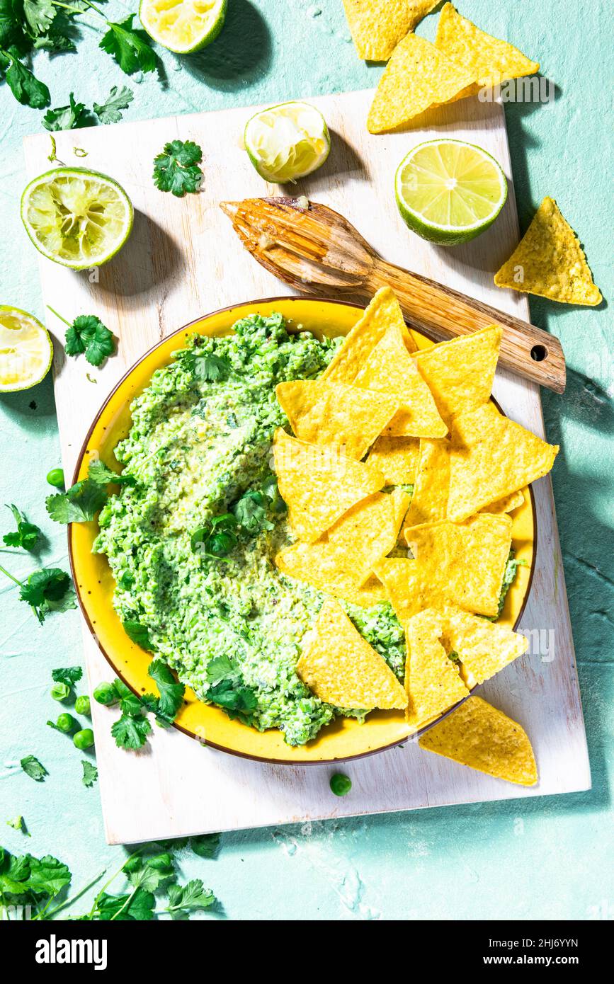 Green Pea guacamole with nachos. Avocado alternative healthy party food ...