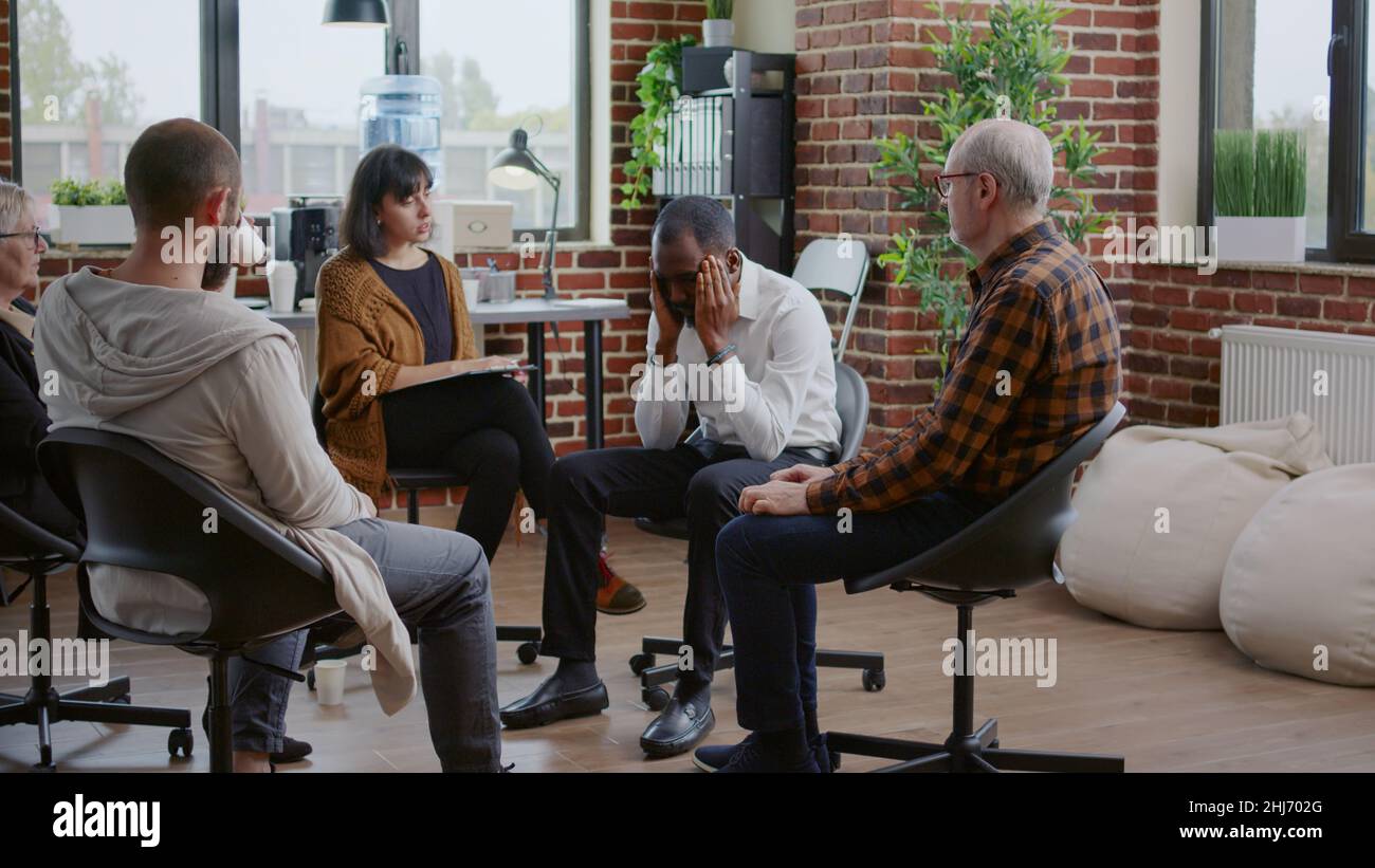 African american man sharing addiction story with group at aa therapy ...