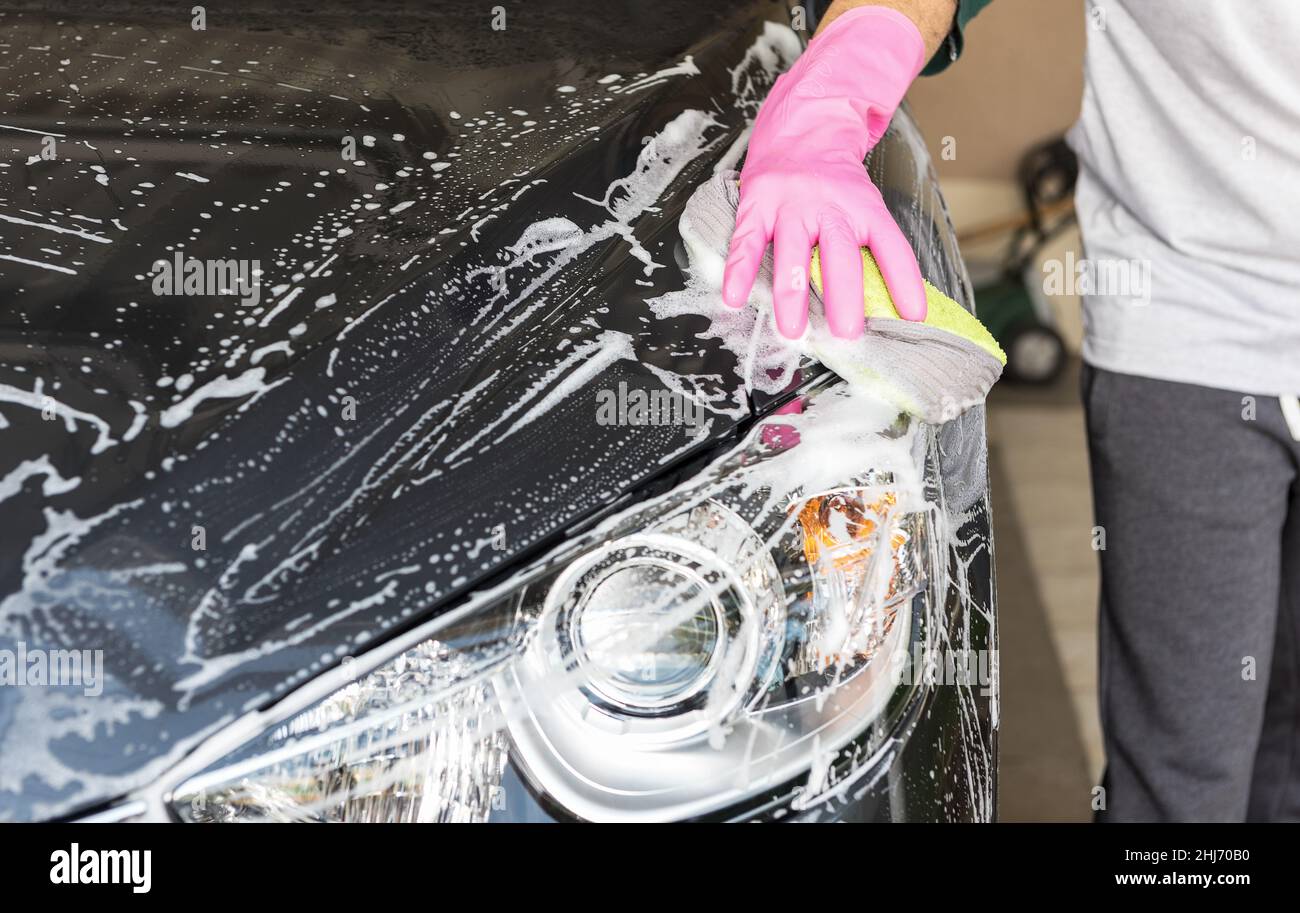 Hand hold sponge over the car for washing Stock Photo - Alamy